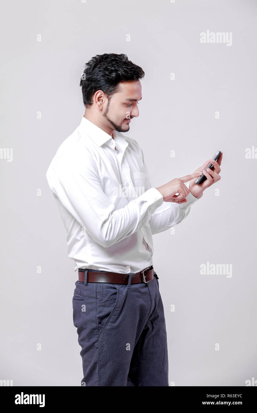 Young indian man using mobile Stock Photo - Alamy