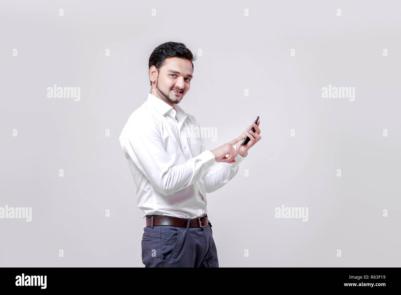Young indian man using mobile Stock Photo - Alamy