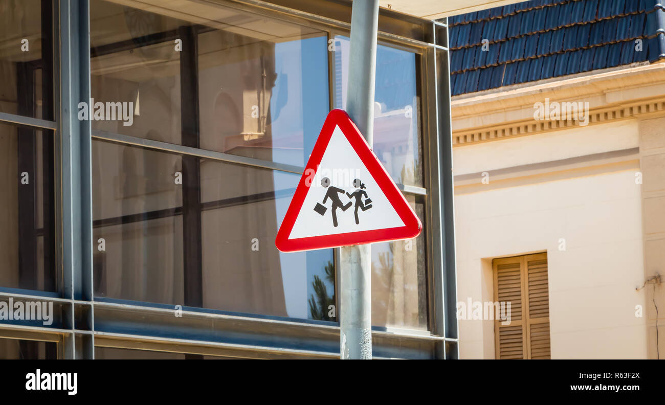 attention to children panel placed in front of a modern glass building ...