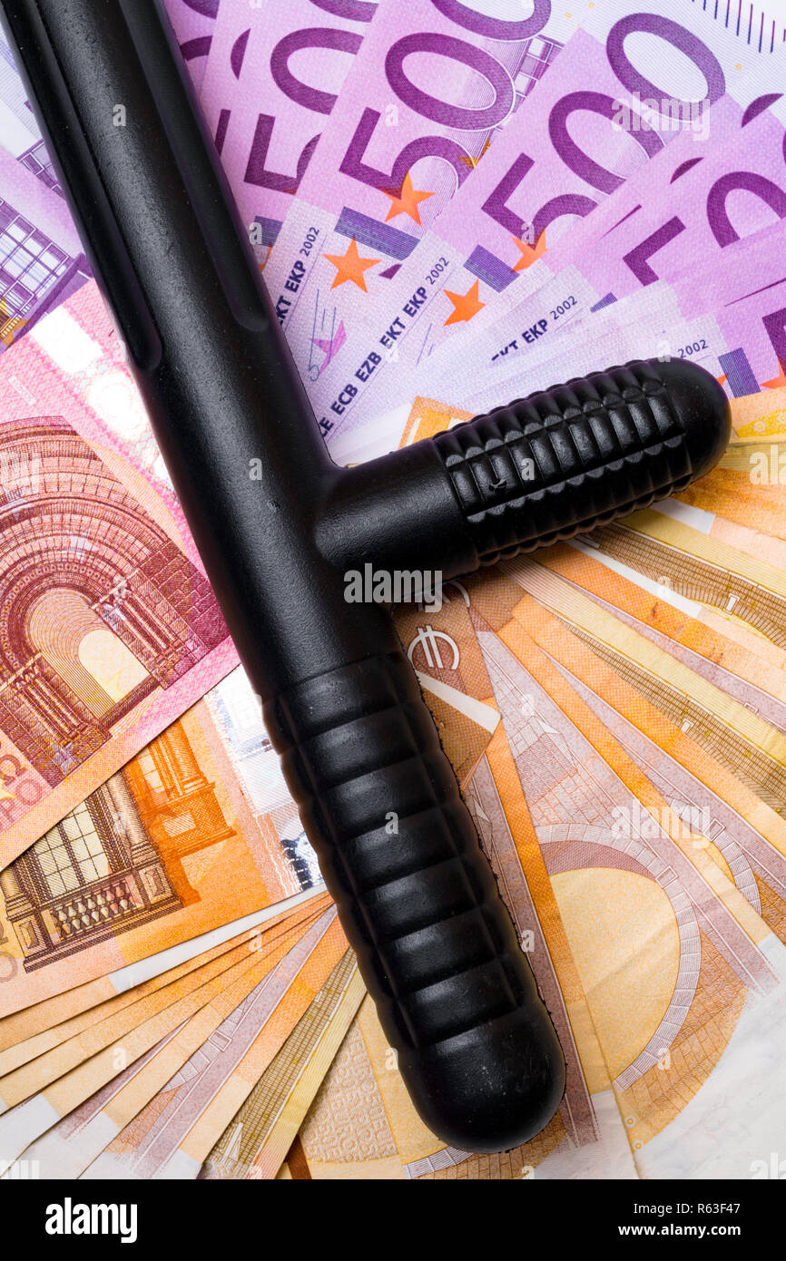 police baton on euro banknotes money cash background. Corruption, dirty ...