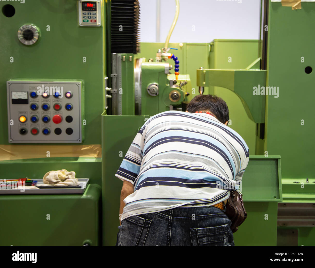 Worker operate CNC machine in factory, industrial machining Stock Photo ... Worker operate CNC machine in factory, industrial machining Stock Photo ...