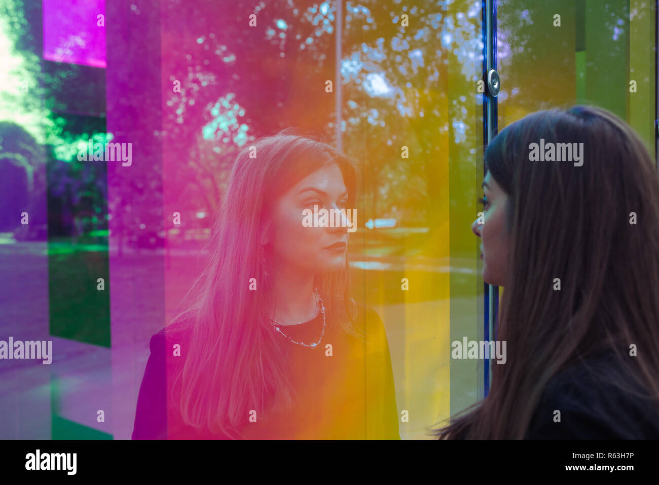 Close up portrait of a woman looking at her own reflection in a ...