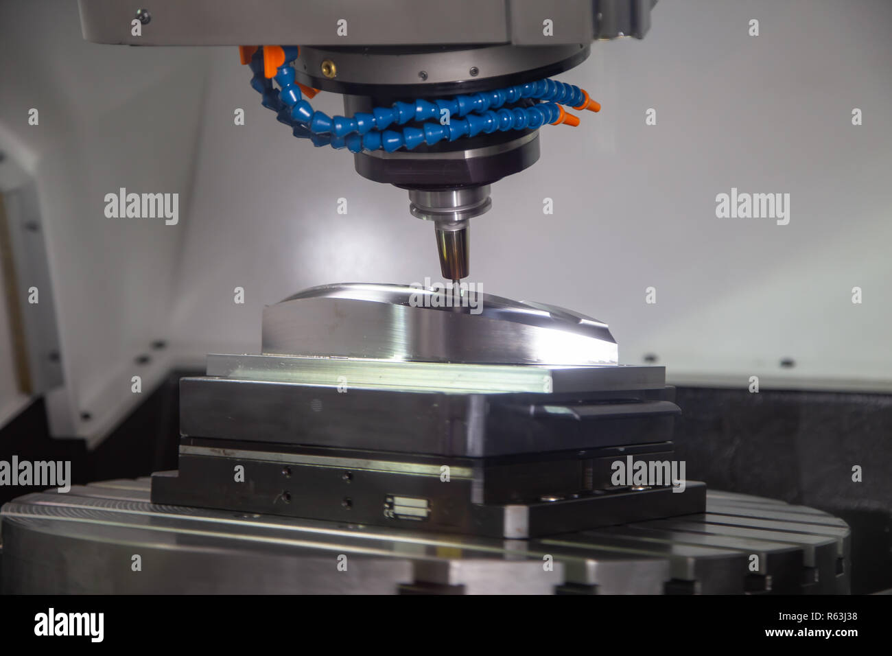 CNC milling machine cutting workpiece, industrial machining Stock Photo ...