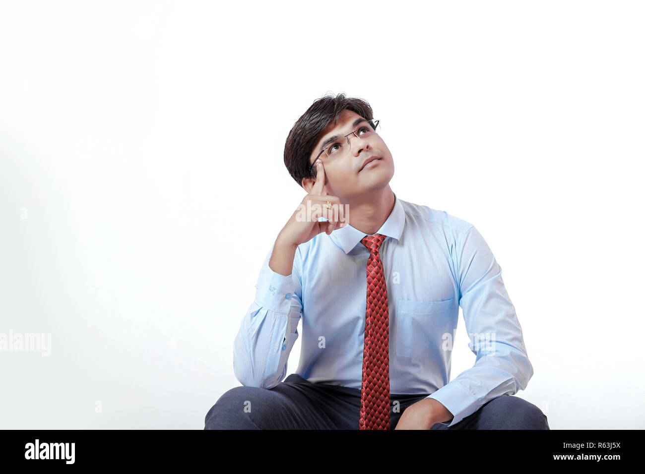 Young Indian business man thinking Stock Photo - Alamy Young Indian business man thinking Stock Photo - Alamy