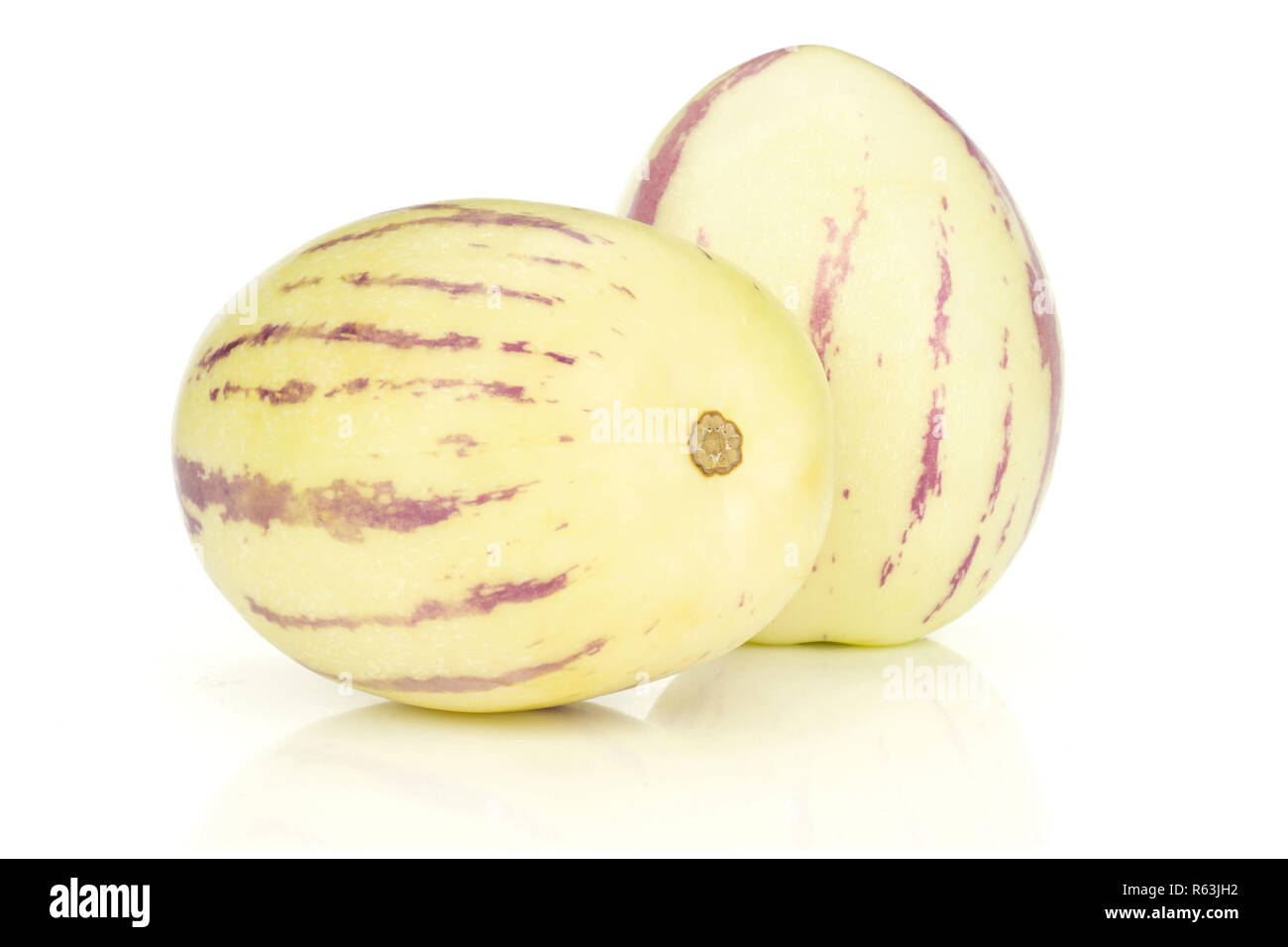 Group of two whole light yellow fresh striped pepino melon isolated on ...