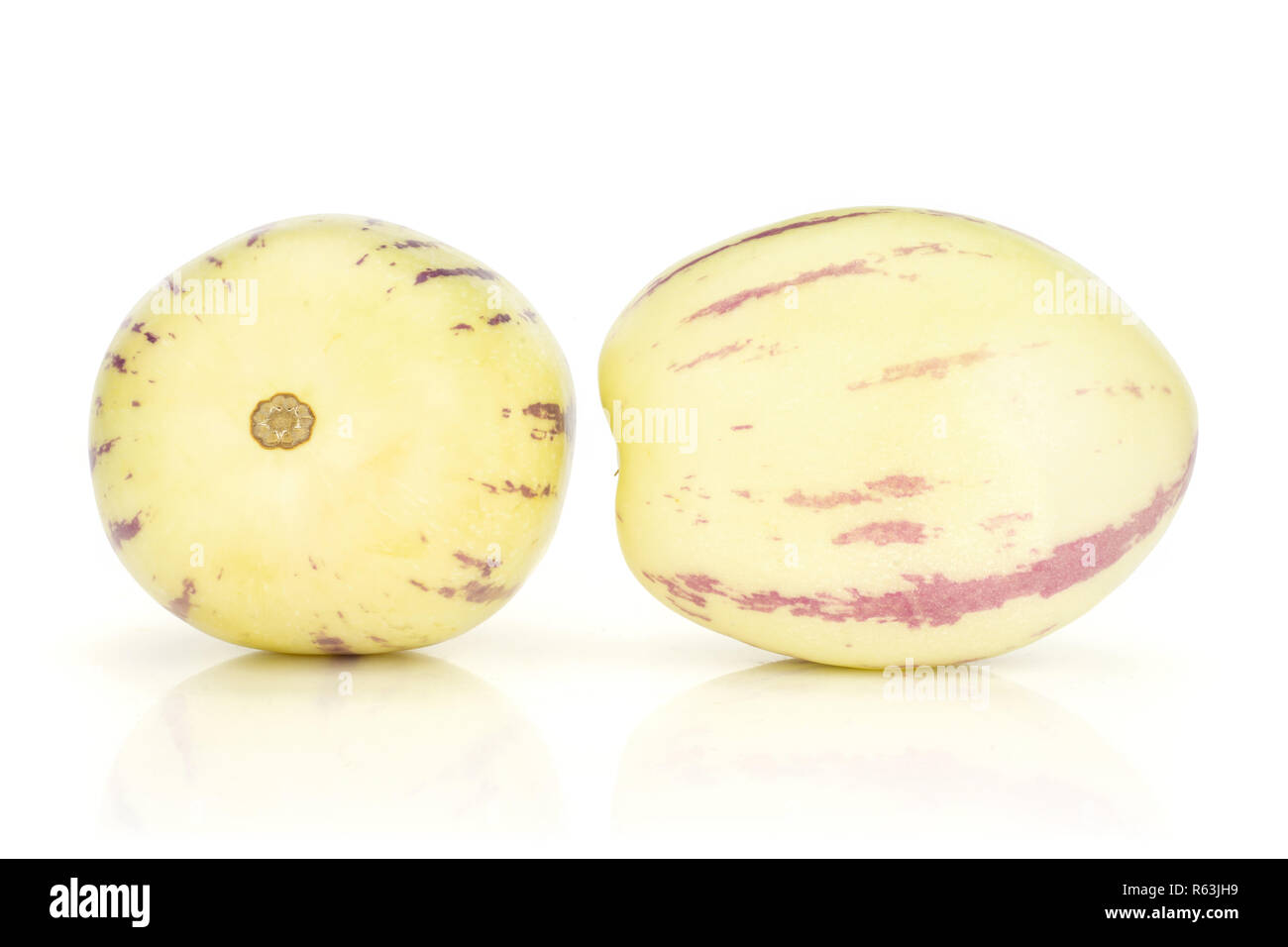 Group of two whole pale yellow fresh striped pepino melon isolated on ...
