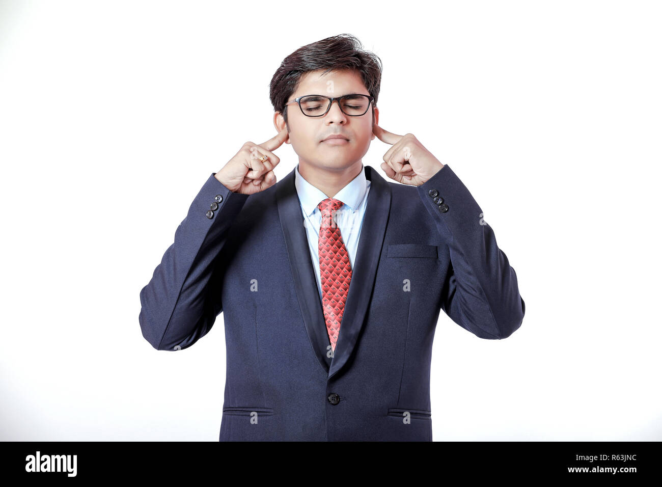Young Indian business man covering ears Stock Photo - Alamy