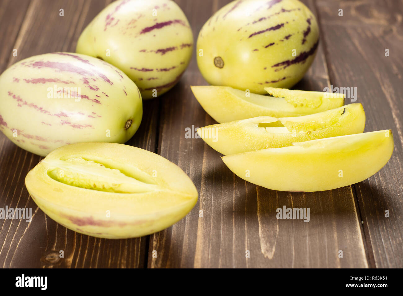 Set of three whole one half three slices of fresh striped pepino melon ...