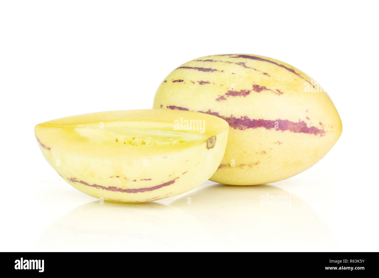 Group of one whole one half of fresh striped pepino melon isolated on ...