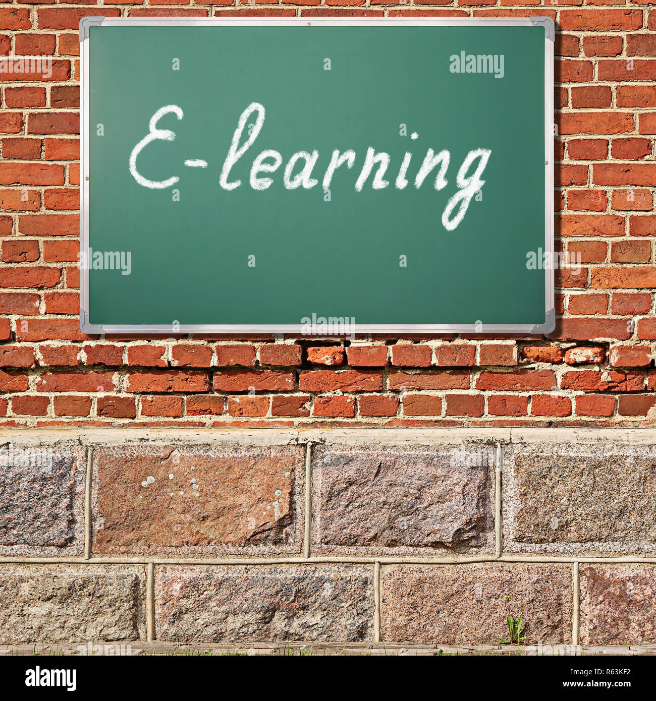 Education theme. Ancient brick wall with E-Learning title on a ...