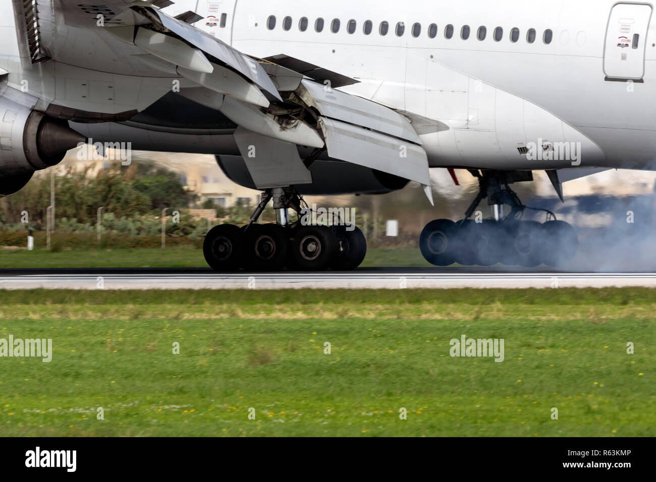 Emirates Boeing 777-300 touching down on runway 31. Spoiler and flaps ...