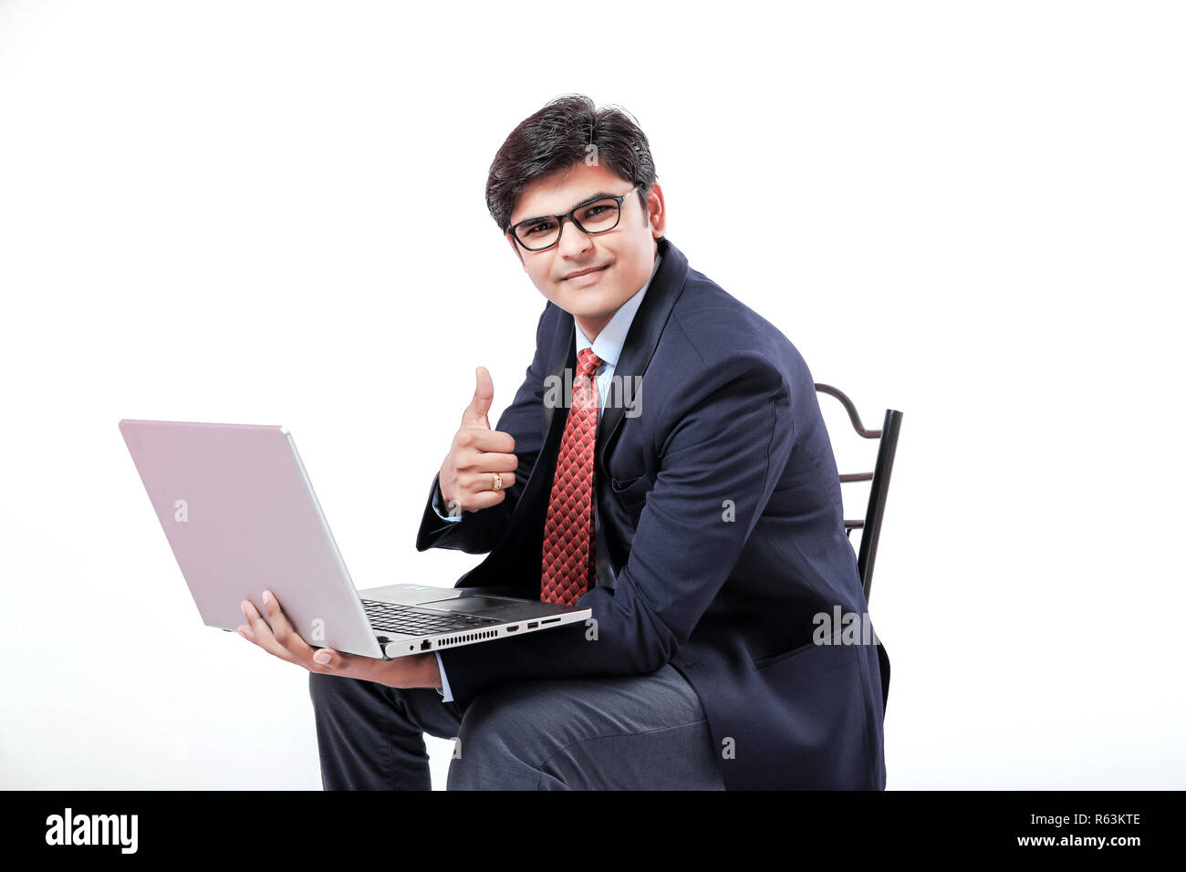 Young Indian businessmen using laptop over isolated background Stock ...