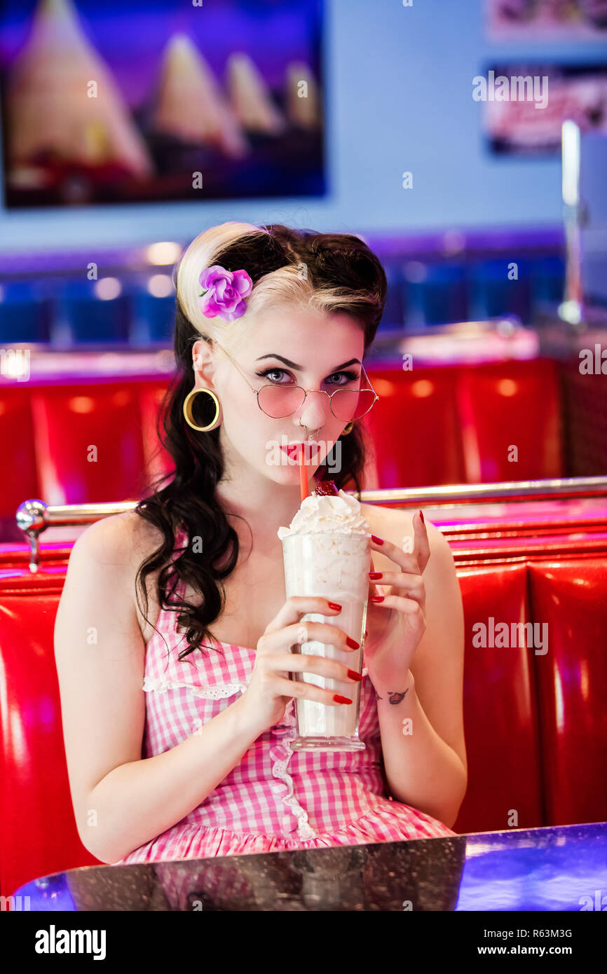 Portrait of a young Pin Up enjoying his milkshake Stock Photo - Alamy