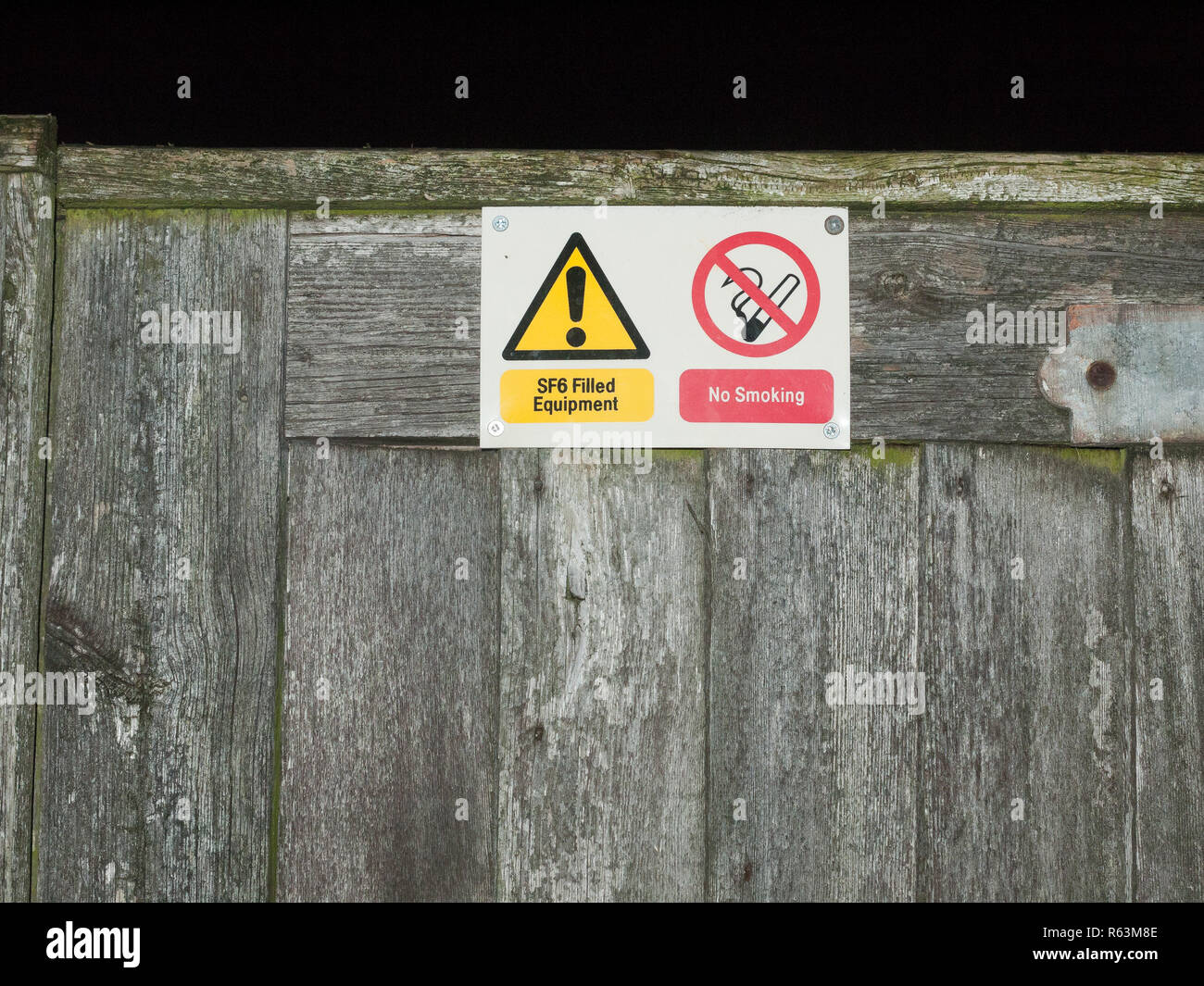 outside no smoking sign warning yellow triangle Stock Photo - Alamy