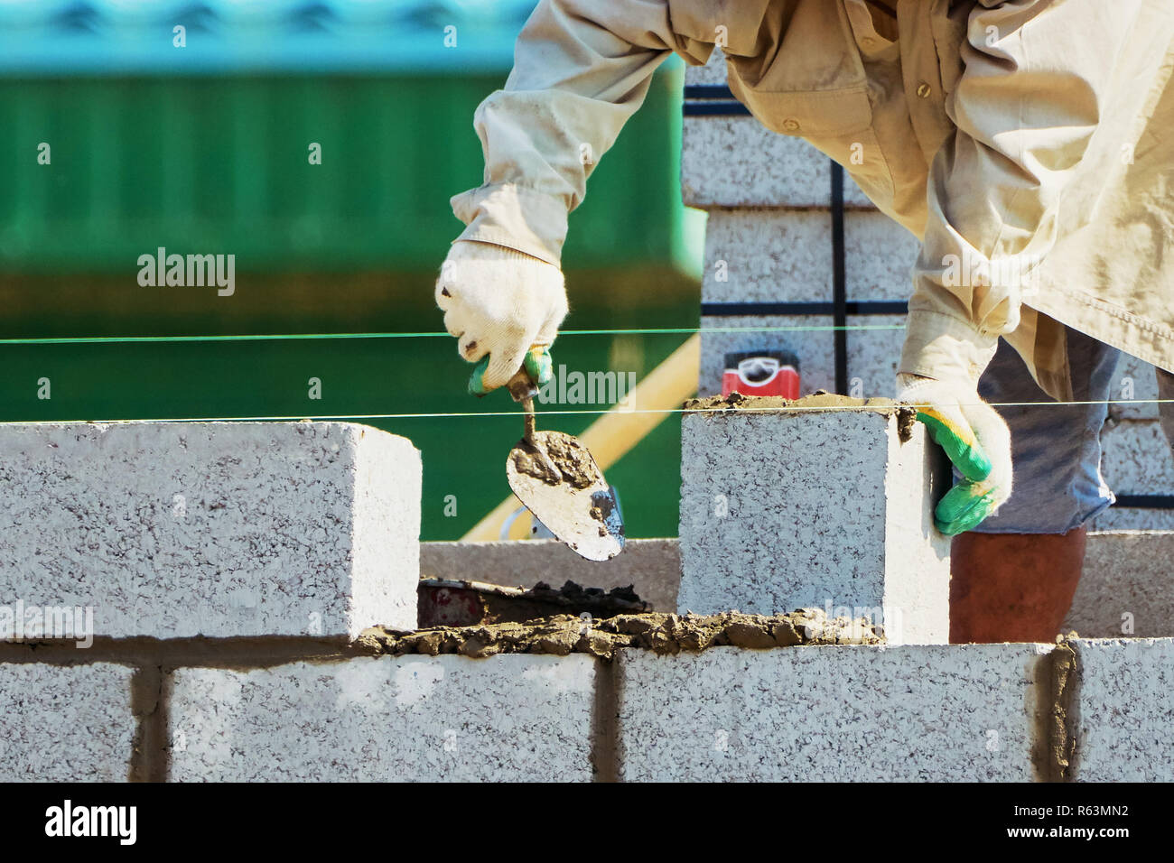 Mason on laying bricks Stock Photo - Alamy