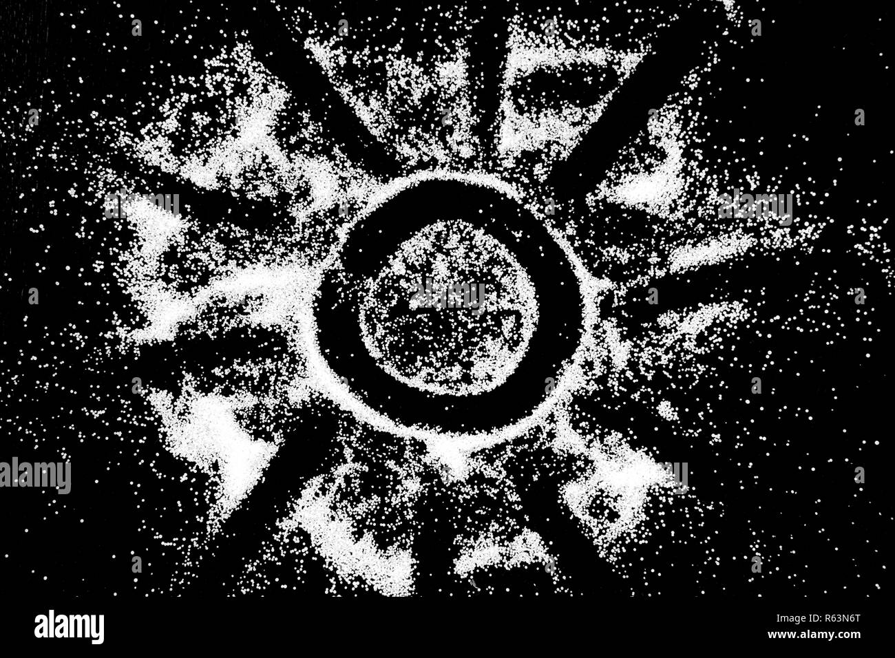 White salt powder sun symbol circle round cloud on black background ...