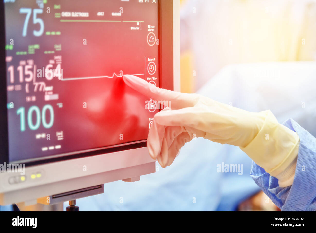 doctor hand touch on electrocardiogram showing patient heart rate in ...