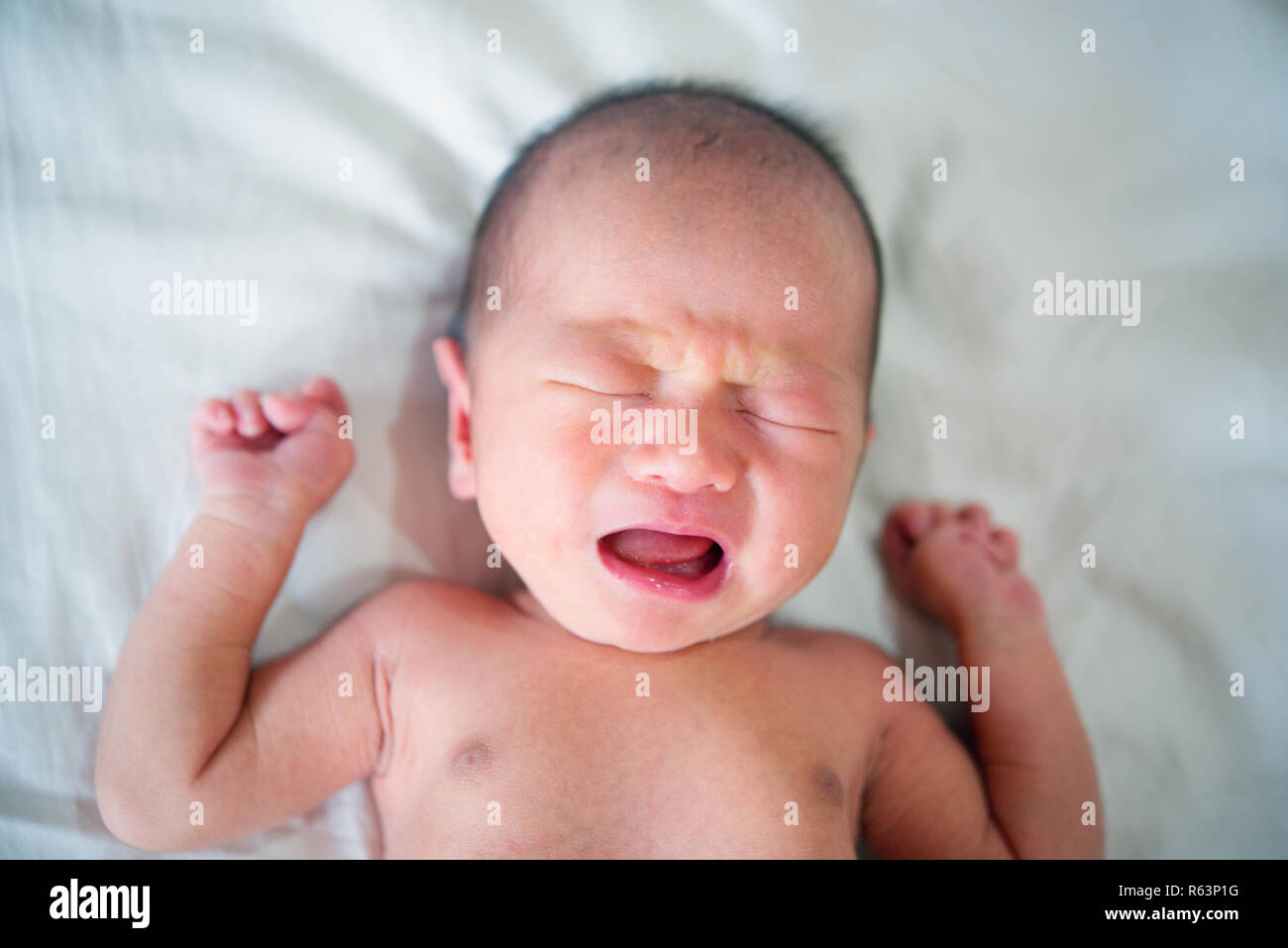 Asian newborn baby boy crying Stock Photo - Alamy