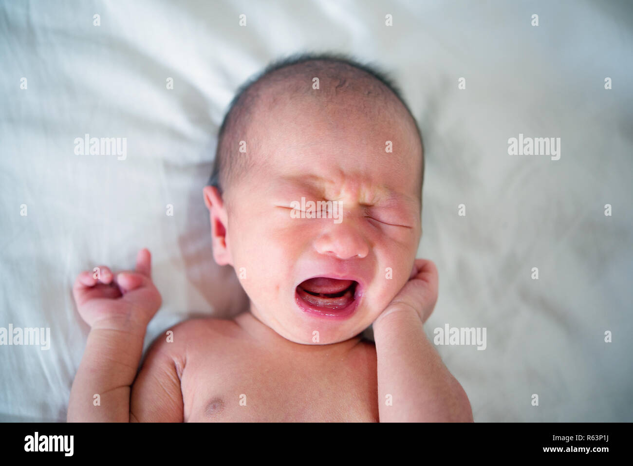 Asian new born baby boy crying Stock Photo - Alamy