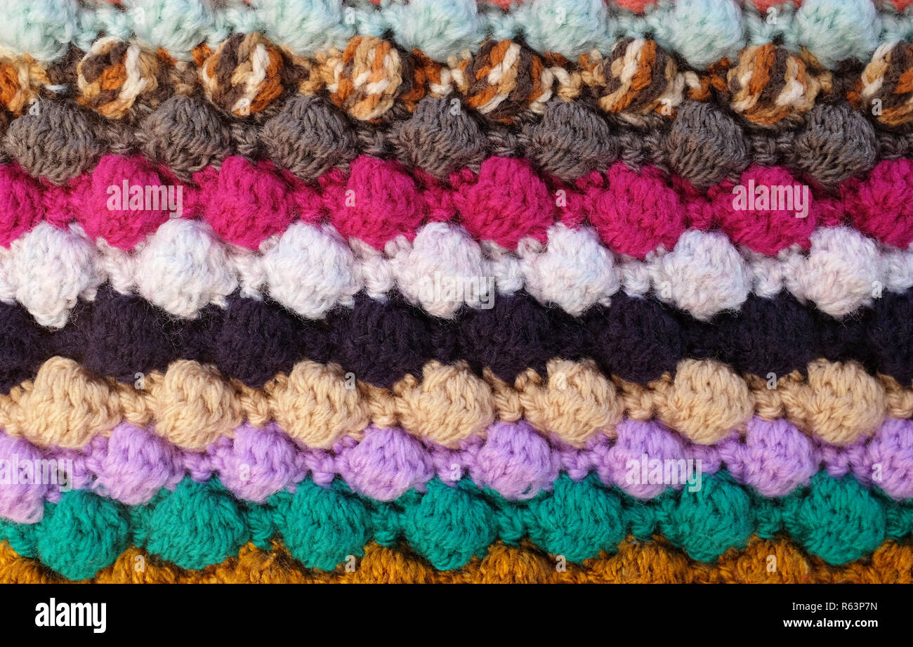 Horizontal multi-coloured stripes of bobble crochet stitches background ...