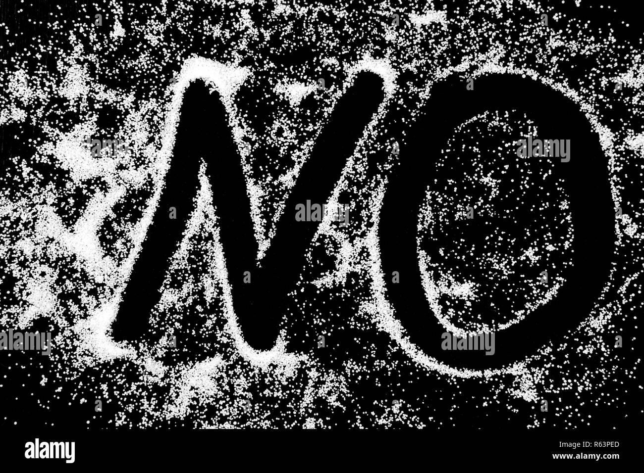 No word symbol drawing by finger on white snow salt powder on black ...
