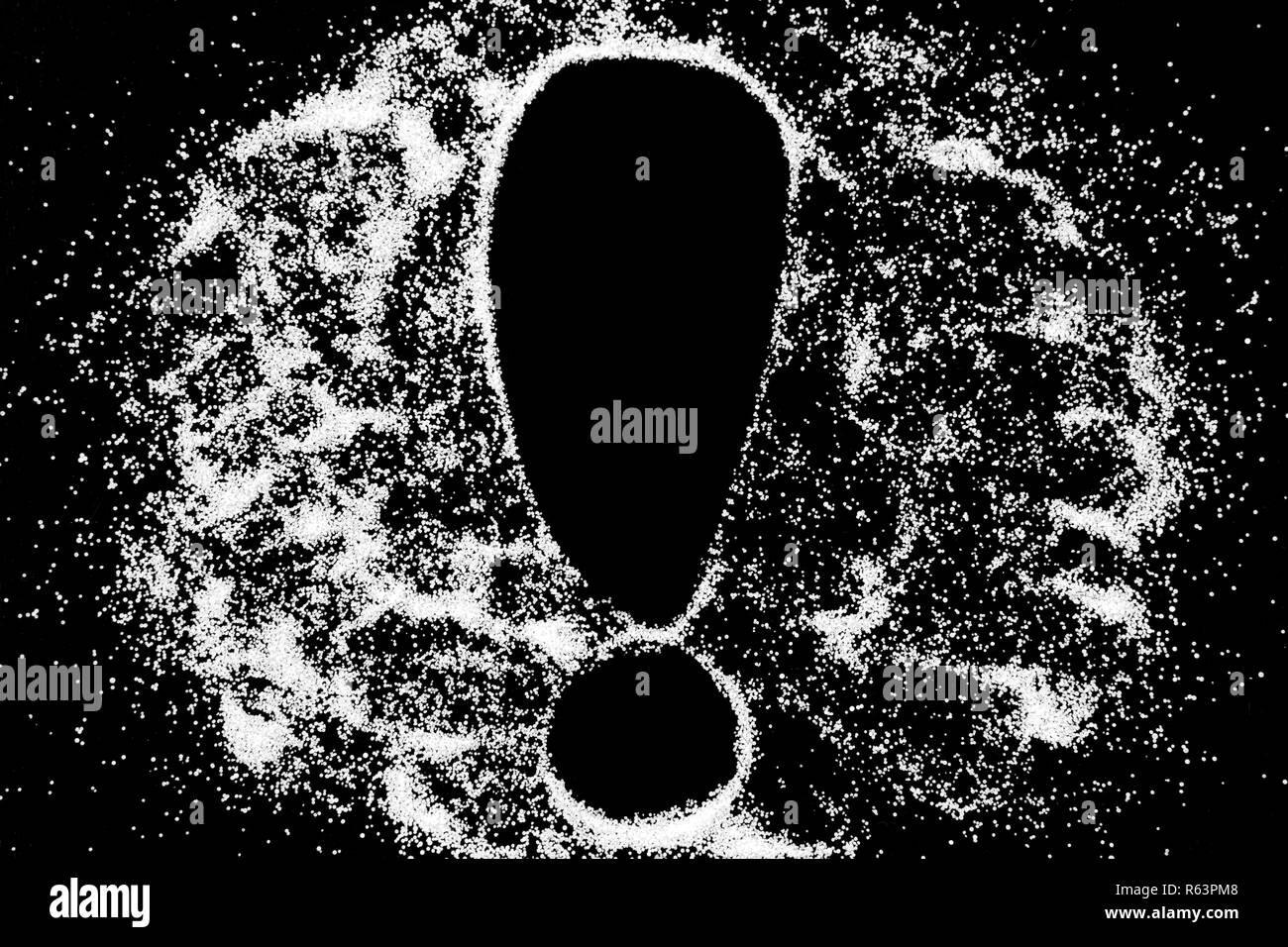 Exclamation mark sign symbol drawing by finger on white snow salt ...