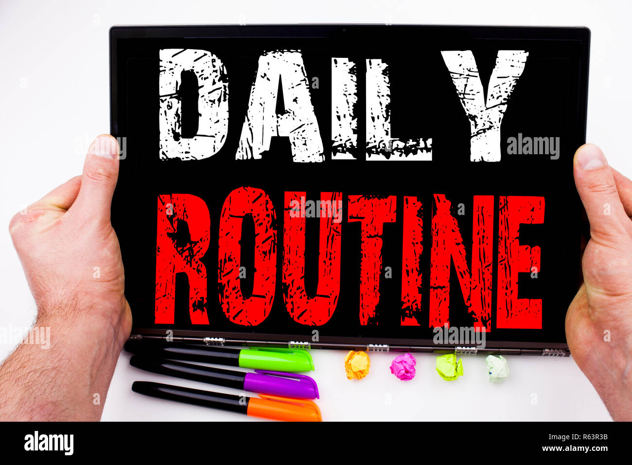 Daily Routine text written on tablet, computer in the office with ...