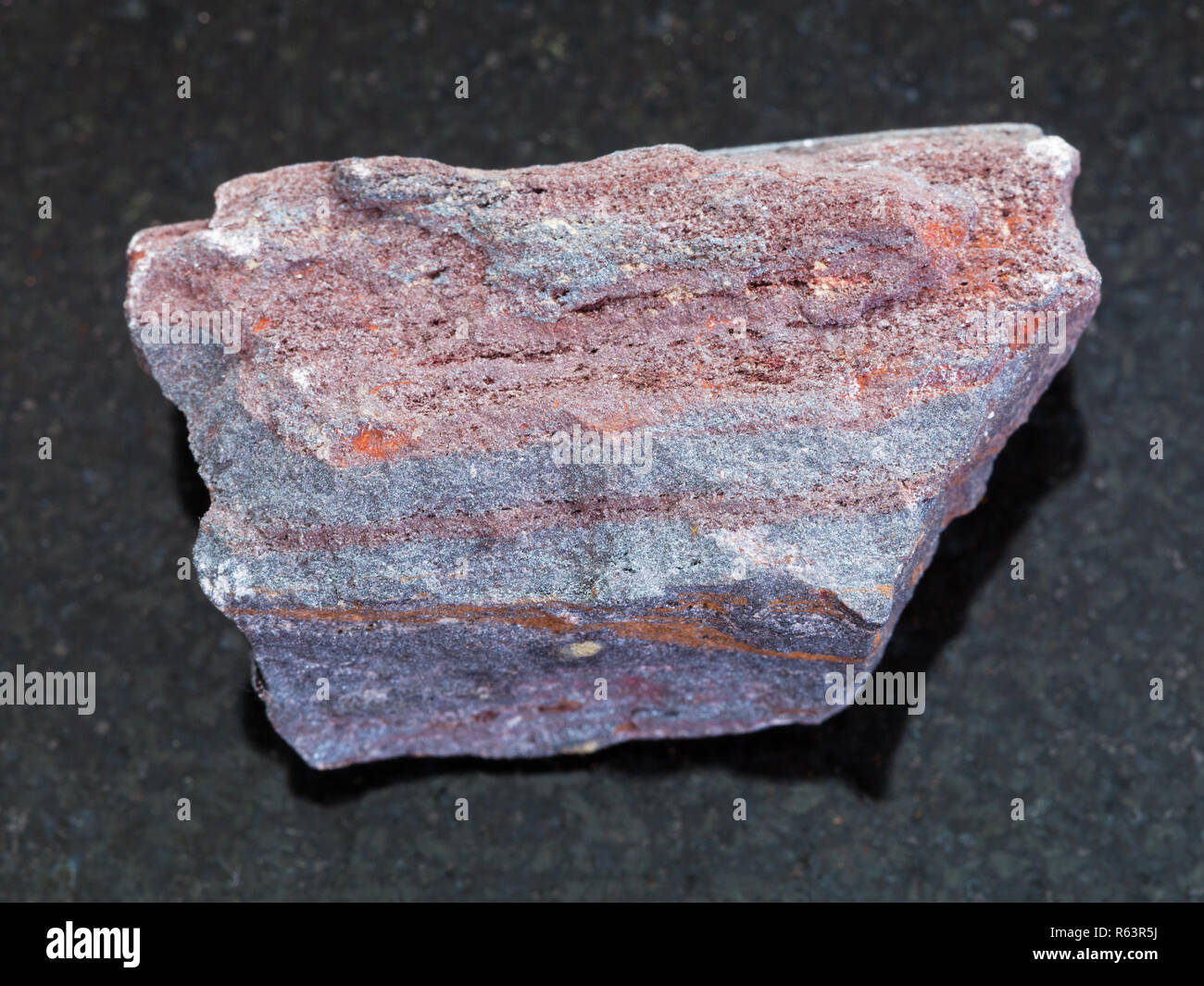 raw jaspilite (ferruginous quartzite) on dark Stock Photo - Alamy