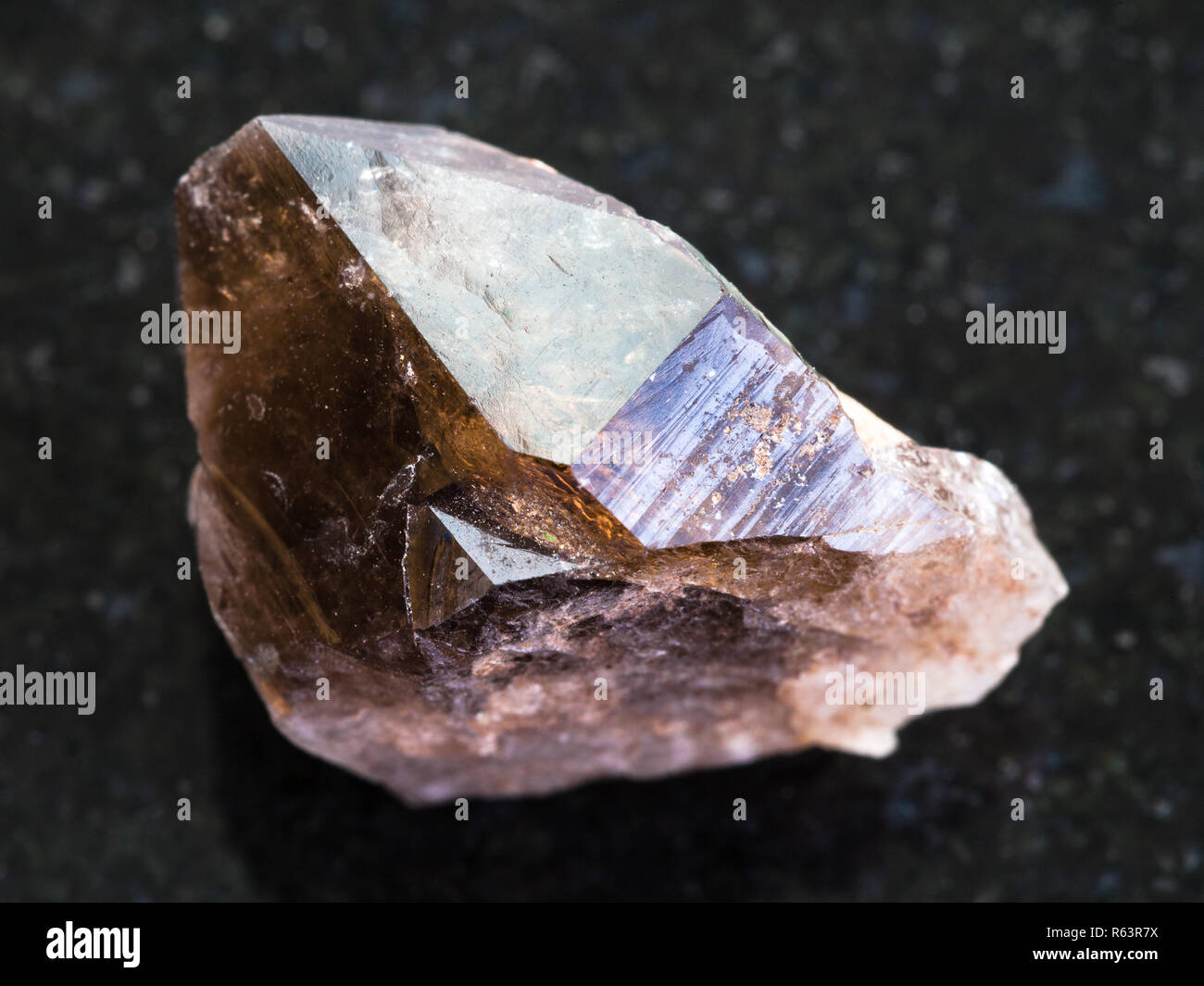 rough crystal of smoky quartz gemstone on dark Stock Photo - Alamy