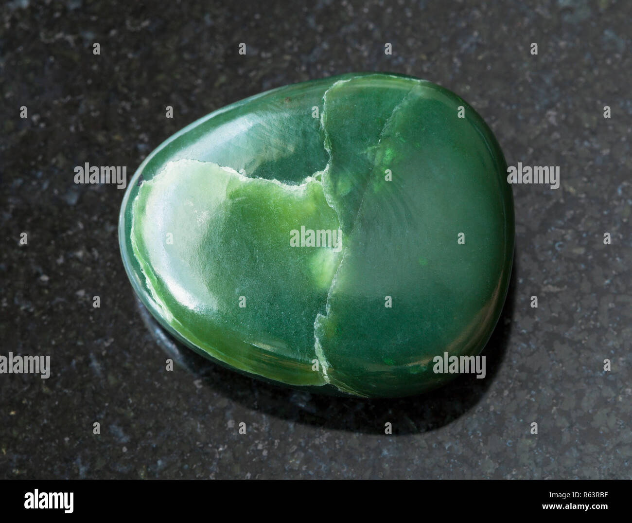 tumbled green nephrite gemstone on dark Stock Photo - Alamy