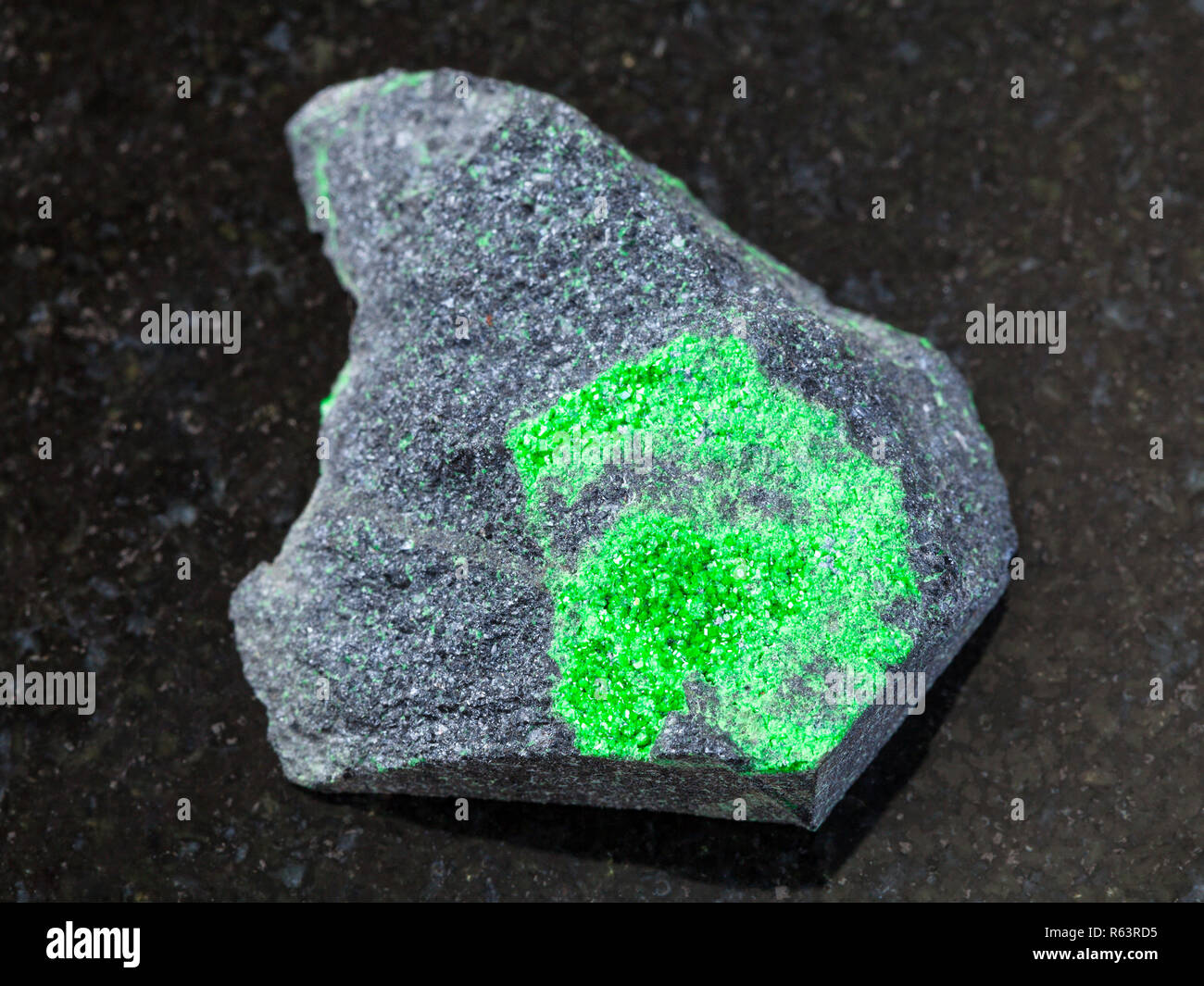 Uvarovite crystals on rough rock on dark Stock Photo - Alamy
