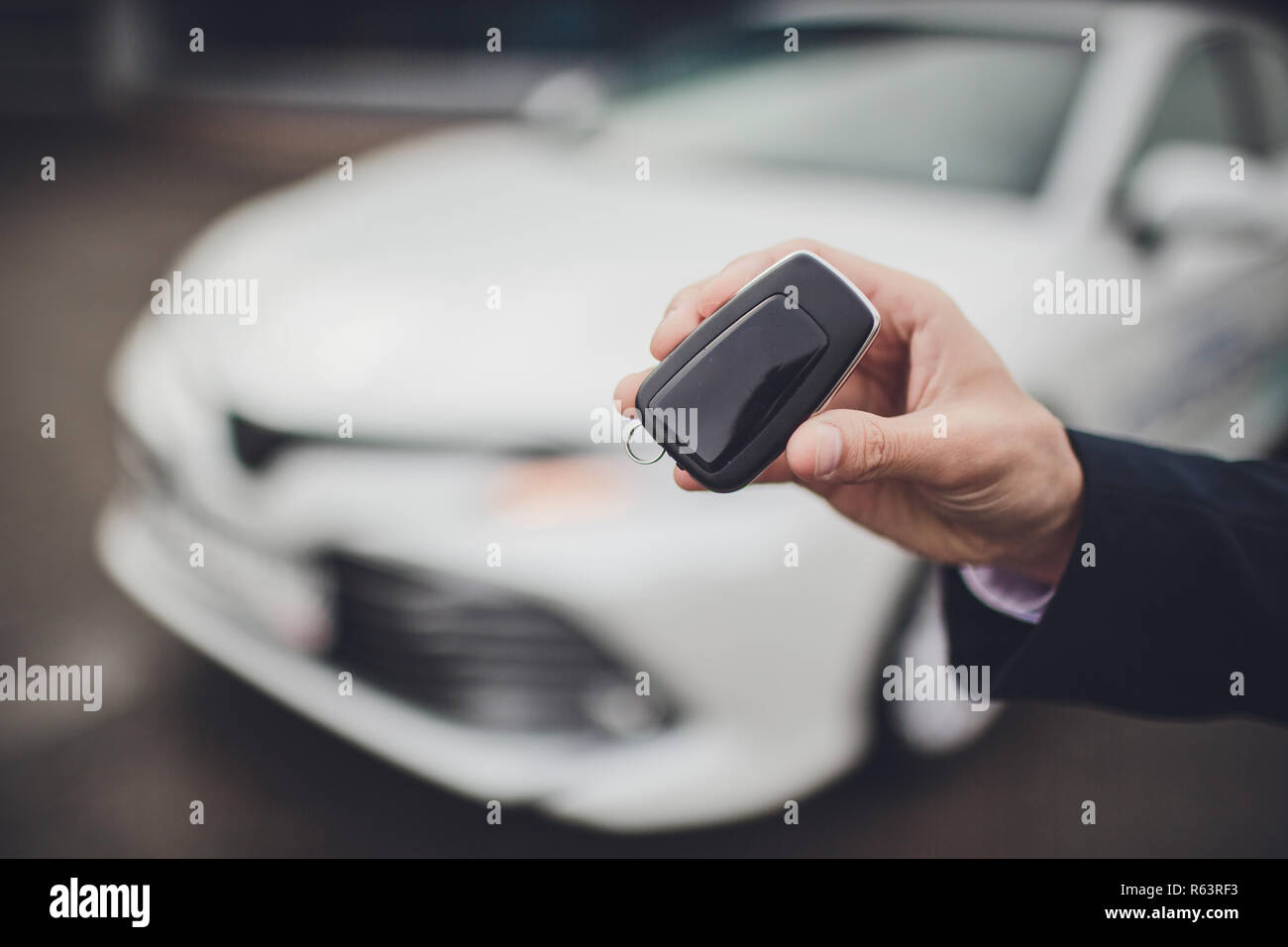 Passing car keys. Cropped closeup car dealer holding out car keys ...
