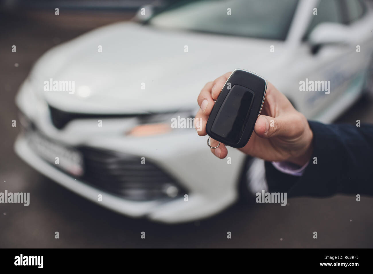 Passing car keys. Cropped closeup car dealer holding out car keys ...
