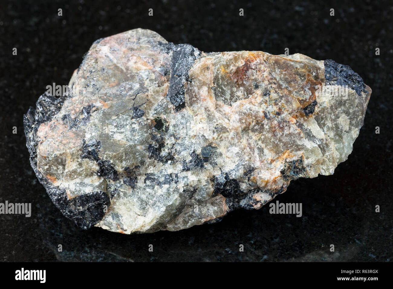 raw green Nepheline stone on dark e background Stock Photo - Alamy
