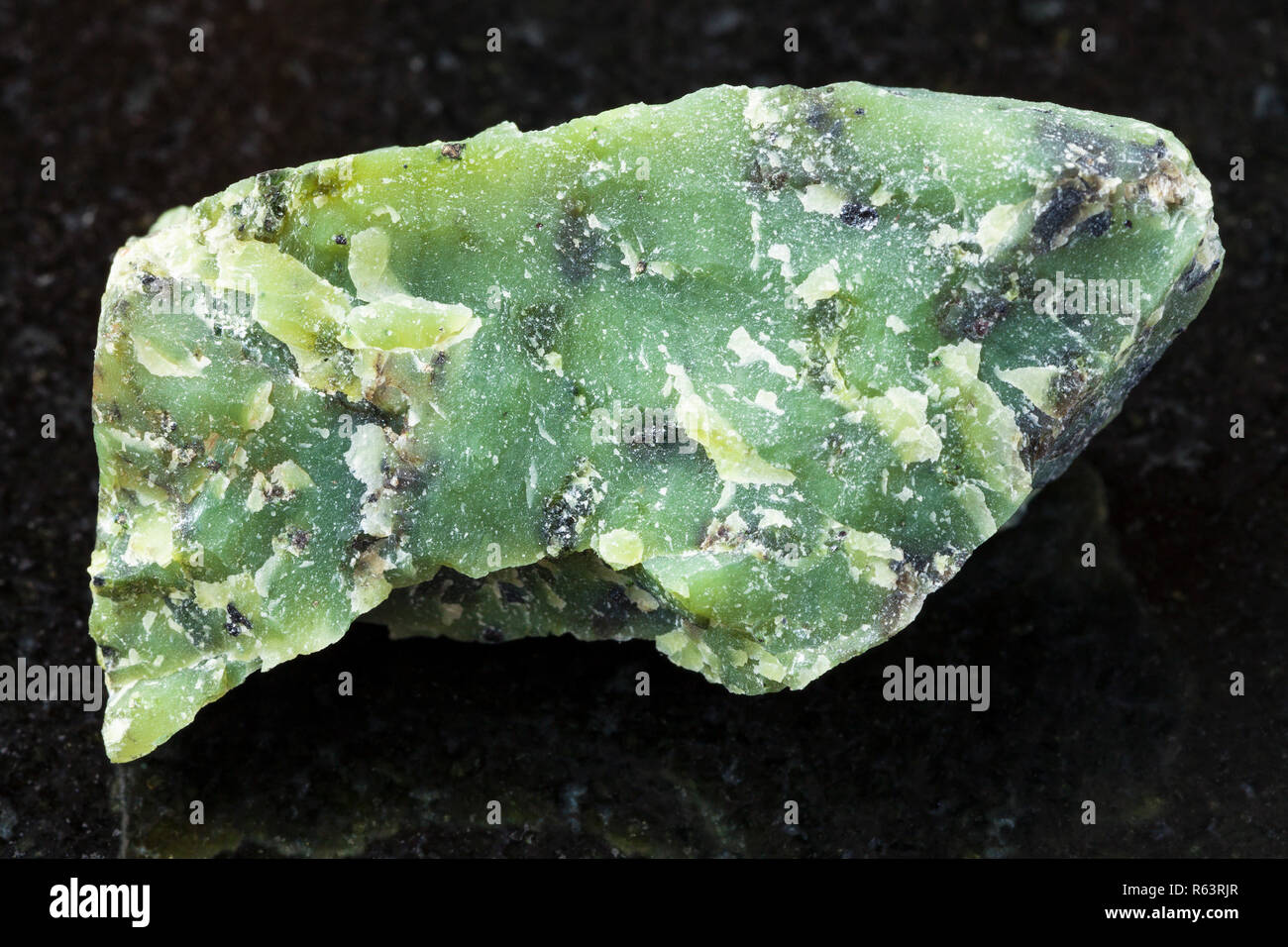 raw Lizardite stone on dark background Stock Photo - Alamy