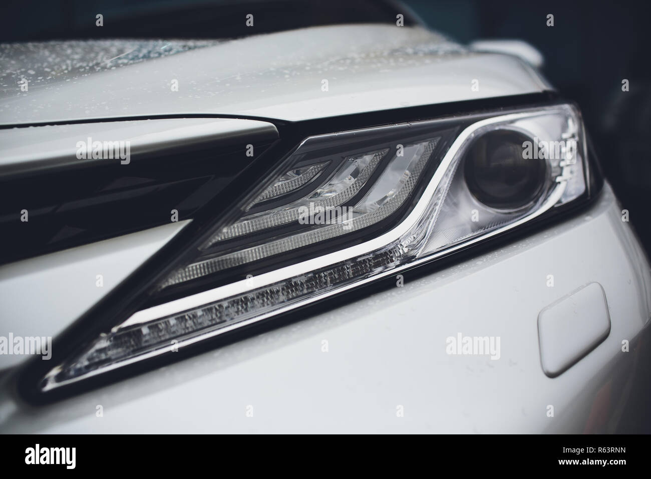front headlight with brilliant reflections auto white body car detail ...