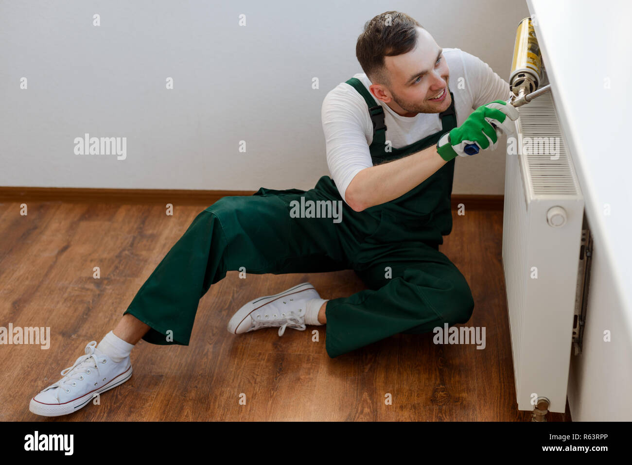Man applying spray foam Stock Photo - Alamy