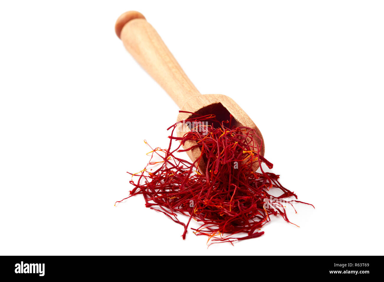 Saffron spice threads (strands) in wooden scoop isolated on white ...
