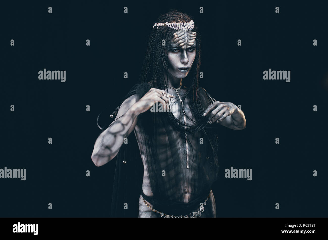 A young woman in the image of a humanoid and extraterrestrial alien ...