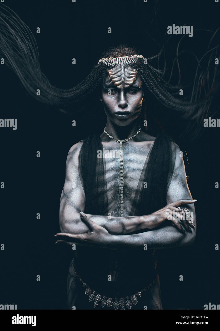 A young woman in the image of a humanoid and extraterrestrial alien ...