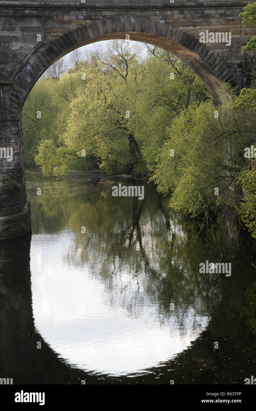 Viaduct arch reflection in water Stock Photo - Alamy