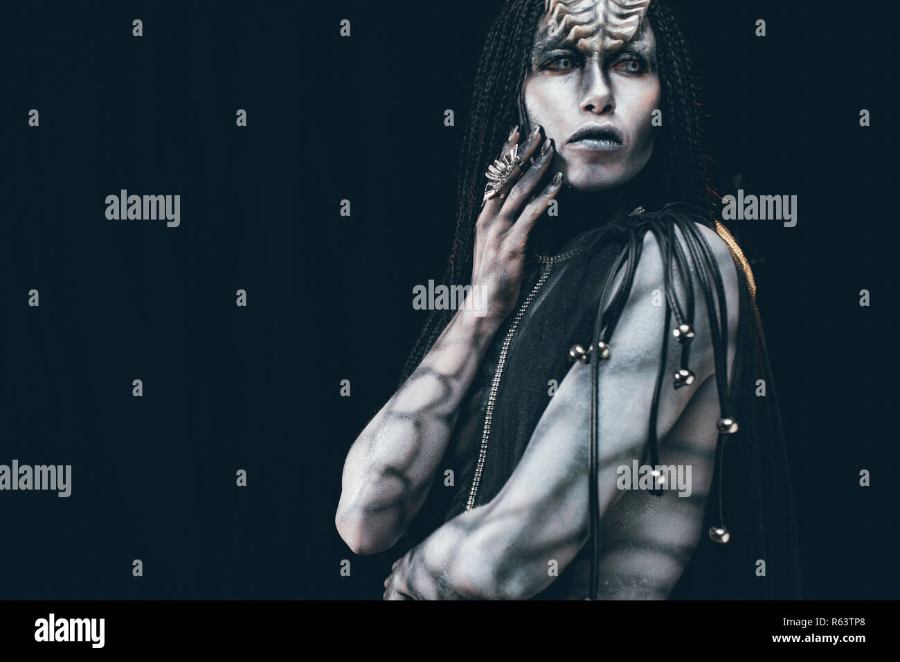A young woman in the image of a humanoid and extraterrestrial alien ...