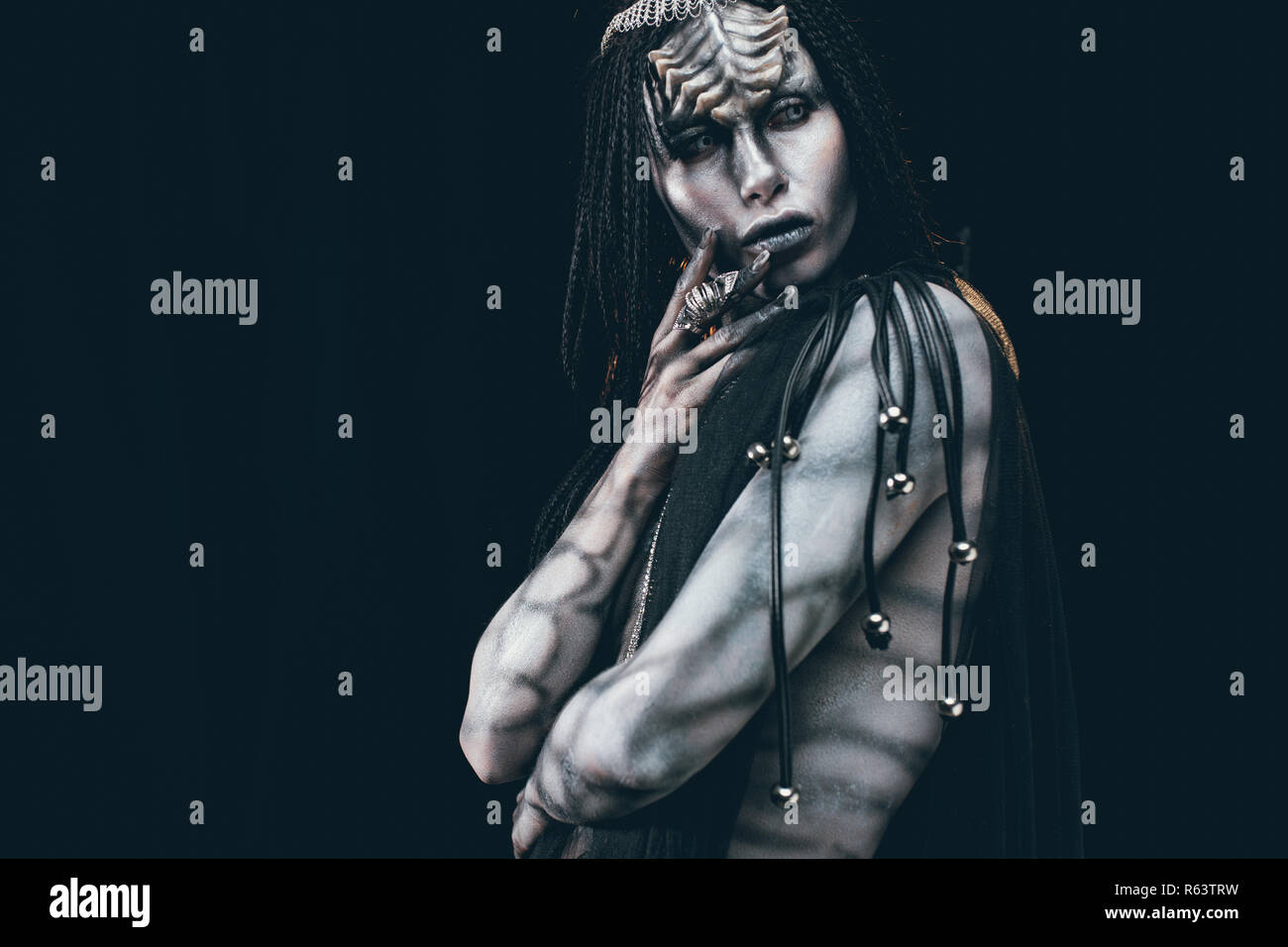 A young woman in the image of a humanoid and extraterrestrial alien ...