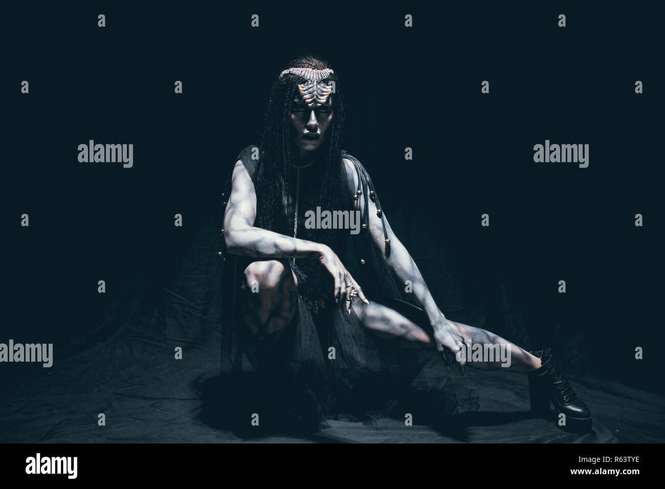 A young woman in the image of a humanoid and extraterrestrial alien ...