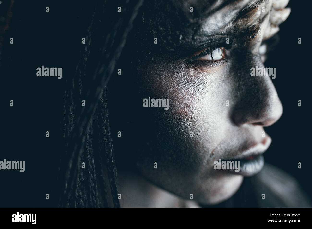 Portrait of young woman in image of humanoid and extraterrestrial alien ...