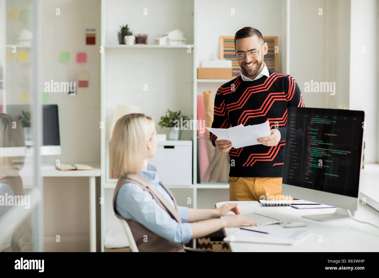 Programmers laughing while discussing new software Stock Photo - Alamy