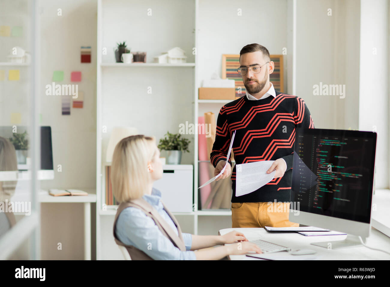 Manager giving paper with task to coding specialist Stock Photo - Alamy