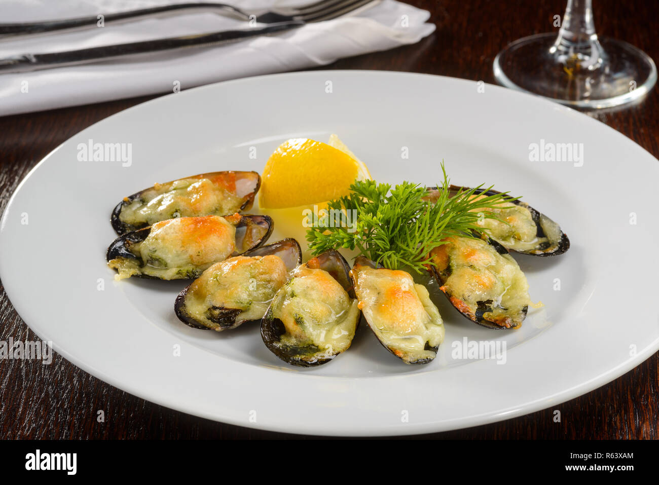 Baked mussels with cheese Stock Photo - Alamy