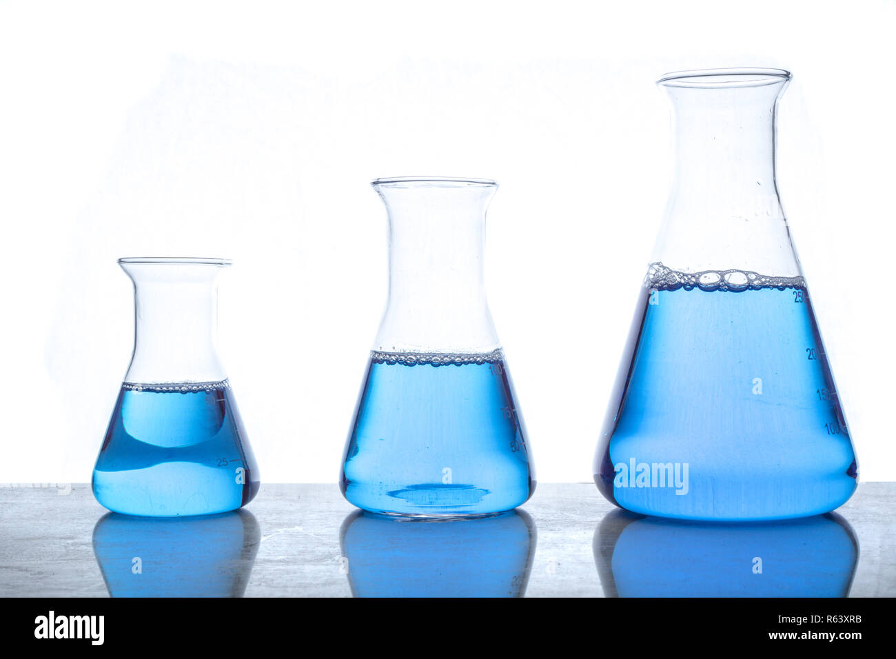 Glass flasks with blue fluid in used in chemistry experiments Stock ...