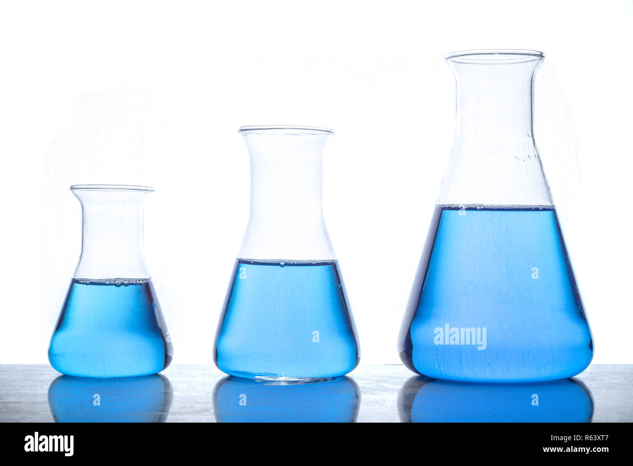 Glass flasks with blue fluid in used in chemistry experiments Stock ...
